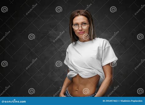 Chic Female In Eyewear Lifts Her Crop Top Revealing A Toned Midriff