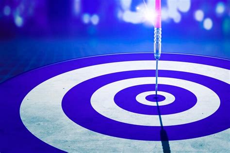 premium photo close up of a dart on center of dartboard