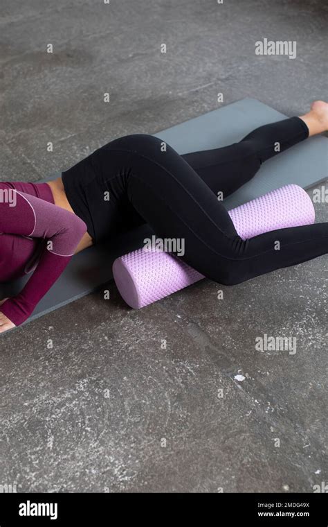A Young Woman In Sportswear Performs A Myofascial Hip Massage With A Roller Muscle Recovery