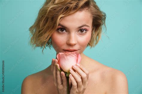 Beauty Portrait Of Naked Woman Posing With Rose Isolated Over Blue