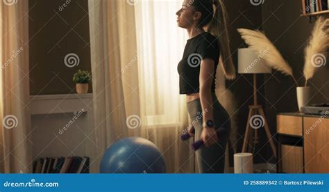 Deep Squat Side View Of A Young Beautiful Woman In Sportswear Doing A