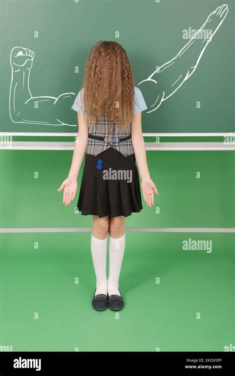 Cute Schoolgirl Over Green Board Background With Strong Arms Drawing