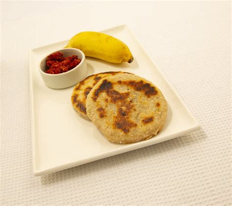 Coconut Roti Chili Sambal With A Banana On A White Plate Stock Image
