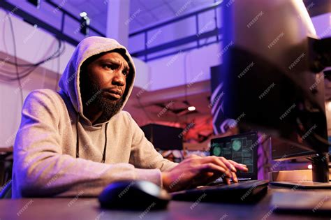 Premium Photo Concerned Hacker Cracking Password And Breaching Into