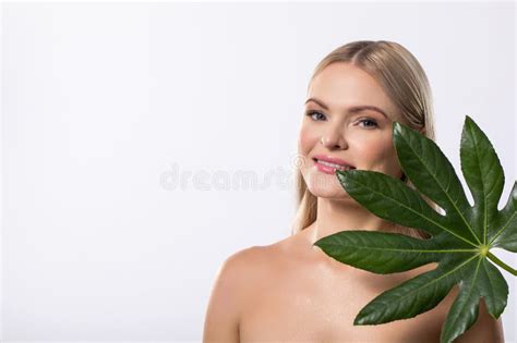This Is An Elegant Model With A Leaf On A Bright Clean Background Showcasing Beauty And Style