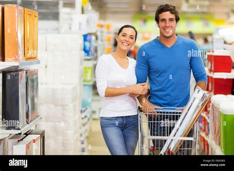 Portrait Of Couple Shopping Together At Supermarket Stock Photo Alamy