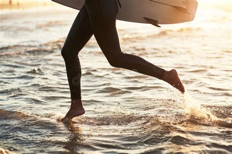 Lifes A Beach An Unrecognizable Young Woman Going Surfing At The Beach