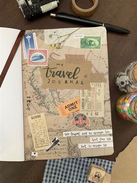 An Open Travel Journal Sitting On Top Of A Wooden Table Next To Some