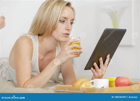 Young Casual Woman Using Tablet In Bed Stock Image Image Of News