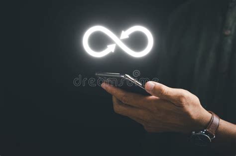 Businessman Presents Smartphone with Infinity Symbol Stock Photo ...