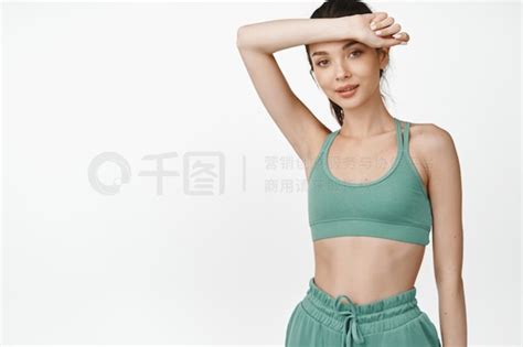 背景高清图片 站在白色背景下穿着运动胸罩进行健身锻炼后，微笑的女运动员擦去额头的汗水 生活方式免费下载格式编号51764744 千图网