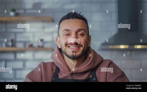 Portrait Of A Smiling Male Chef In A Modern Kitchen Wearing A Casual