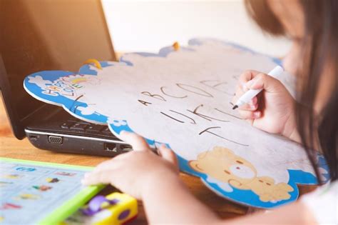 Premium Photo Midsection Of Girl Drawing On Table