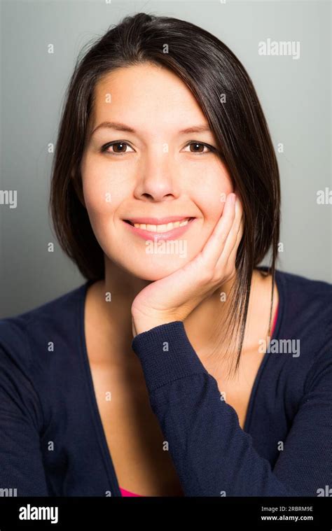 Beautiful Young Brunette Woman With A Lovely Warm Smile Resting Her