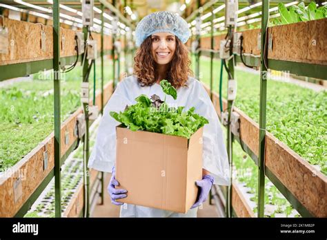 Joyful Female Gardener Looking At Camera And Smiling While Holding