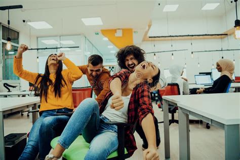 Team Building And Office Fun Young Cheerful Businesspeople In Smart
