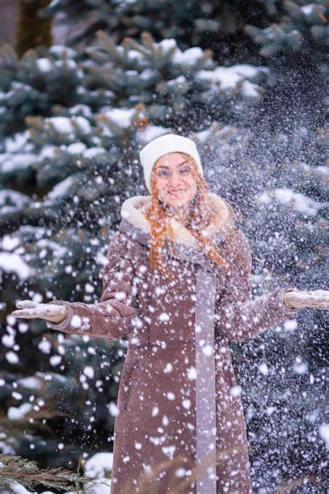 Winter Ginger Redhead Girl Throwing Snowball At Camera Smiling Happy