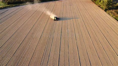 Tractor With Roller Rides Field Extruding Ground Compact Soil Evelling