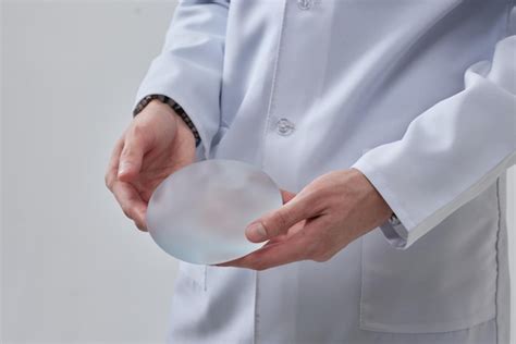 Premium Photo Silicone Breast Implant In The Hand Of A Plastic