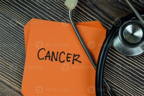 Concept Of Cancer Write On Sticky Notes Isolated On Wooden Table