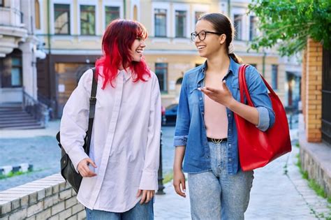 Premium Photo Two Walking Talking Laughing Teenage Girls Walking Down