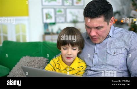 Father And Son Using Laptop Handsome Father Looking At Computer With