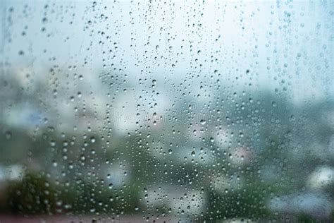 Raindrops On The Glass Outside The Window Cloudy Sky And Greenery Stock