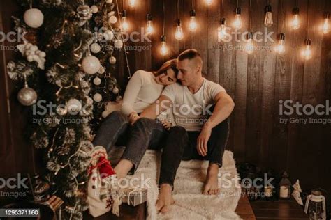 나무 창턱의 창문 근처에서 크리스마스 트리 근처에서 키스하는 남자와 소녀 가정의 방에 대한 스톡 사진 및 기타 이미지 가정의 방 겨울 꽃 식물 Istock