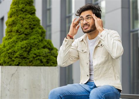 Displeased Sick Indian Man Rubbing Temples To Cure Headache Problem