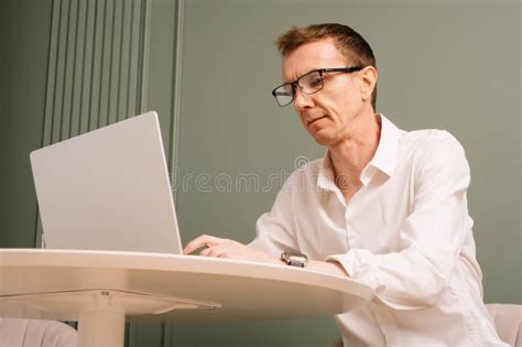 Hard Working Business Man In Glasses White Shirt Sitting At Table And