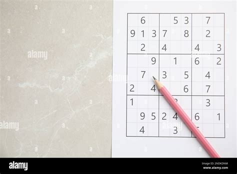 Sudoku And Pencil On Light Marble Table Top View Space For Text Stock