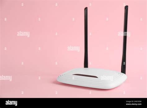 Modern Wi Fi Router On Light Pink Background Space For Text Stock Photo Alamy