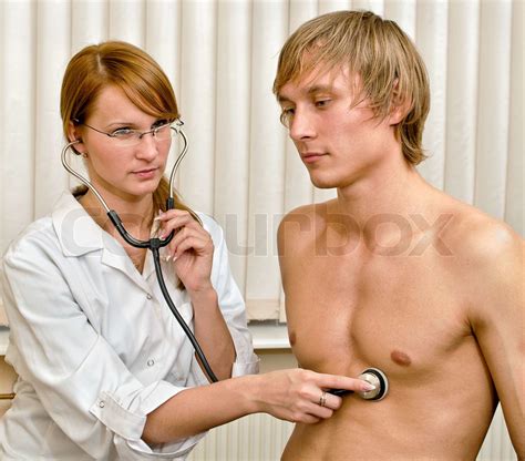 Young Female Doctor Examine Male Patient With Stethoscope Stock Image
