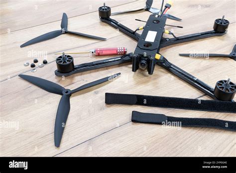 Disassembled Sport Fpv Drone Body With An Electric Motor Lies On A Work Table Alongside Diy