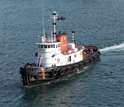 White And Orange Tugboat In Blue Waters Free Stock Photo Freeimages