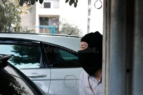 Masked Thief In Black Balaclava Trying To Break Into Car Criminal