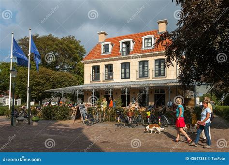Street With Tourists And Hotel On The Island Schiermonnikoog Ne