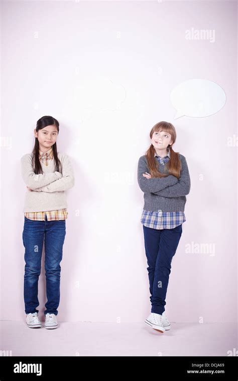 Two Girls Standing Together While One Girl Has Speech Bubble Stock