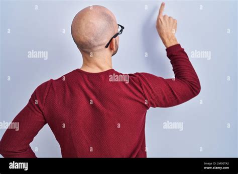 Young Bald Man With Beard Standing Over White Background Wearing