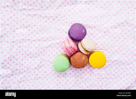 Multicolored Cake Macaron Or Macaroon In The Triangle Form On The White