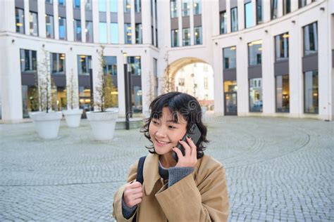 Cellular Technology Young Korean Woman Talks On Mobile Phone Makes A