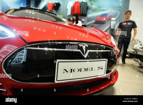 FILE Chinese Car Buyers Look At A Tesla Model S Electric Car At A Flagship Store Of Tesla In