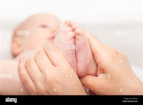 Physiotherapist Performing Leg Development Exercise With Infant