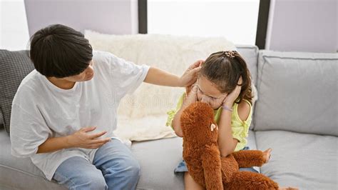 Stressed Mother And Daughter Covering Ears Disagreeing With Each Other