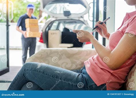 Woman Courier Holding A Parcel Shipping Mail Appending Signature