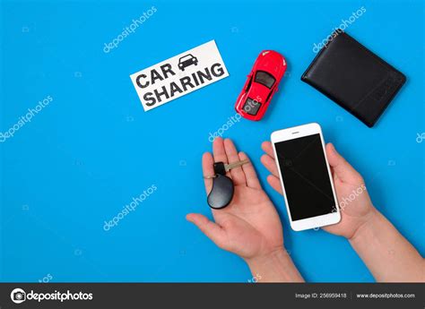 Car Sharing App Concept Toy Car Auto Drive License Human Hand With Smartphone And Car Key