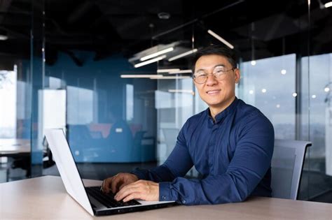 Premium Photo Successful Asian Businessman Smiling And Looking At