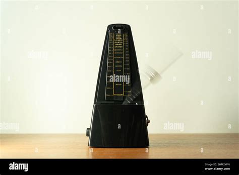 Metronome With Swinging Pendulum Shot With Motion Blur Effect Stock