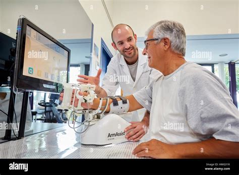 Therapist And Patient With Assistive Robot For Upper Limb Rehabilitation The Robot Armassist