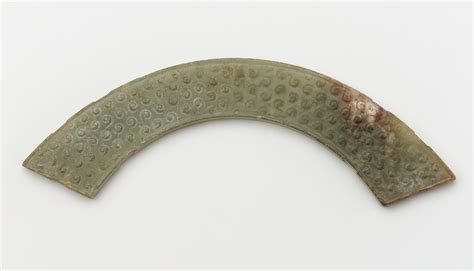 Pendant With Raised Uniform Curls Arranged In A Grid And Inscription